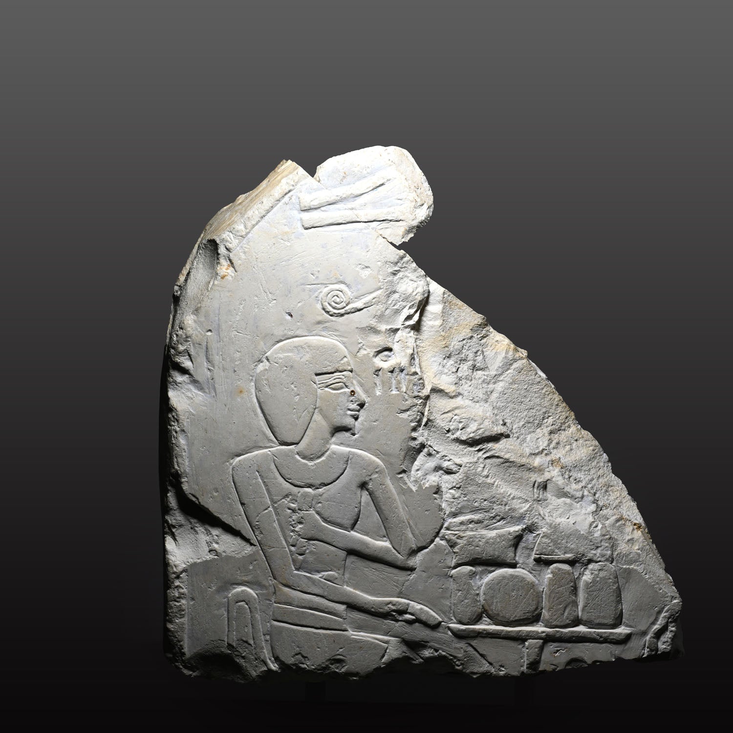An Egyptian Limestone Stele Fragment, New Kingdom, early 18th Dynasty,